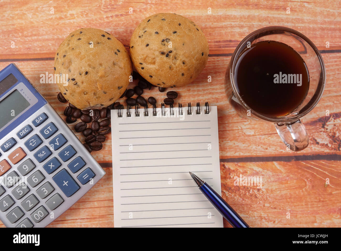 Morning breakfast concept with coffee,bun, post it notes on wooden ...