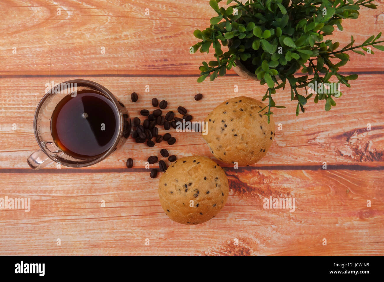 Morning breakfast concept with coffee,bun, post it notes on wooden ...
