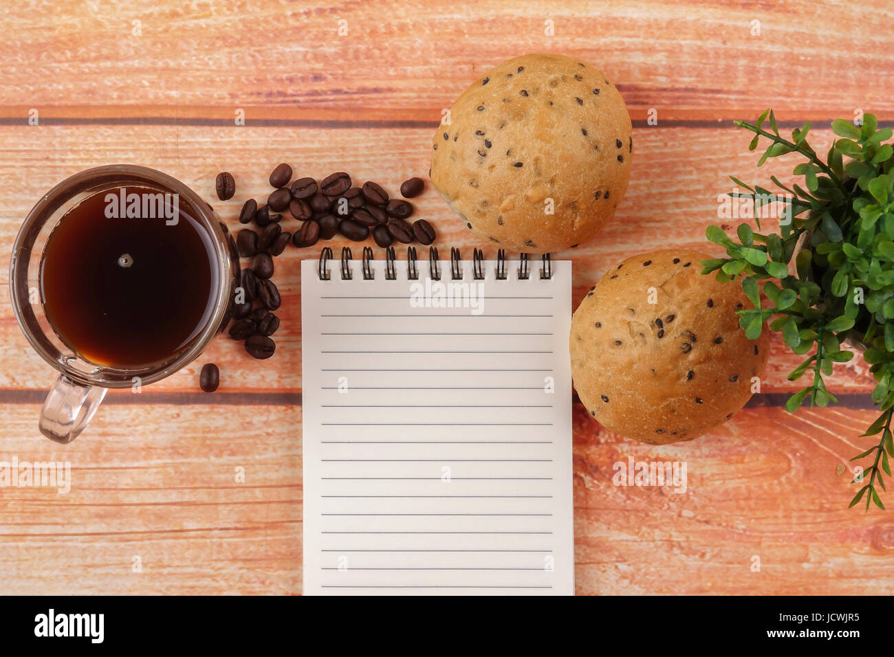Morning breakfast concept with coffee,bun, post it notes on wooden ...
