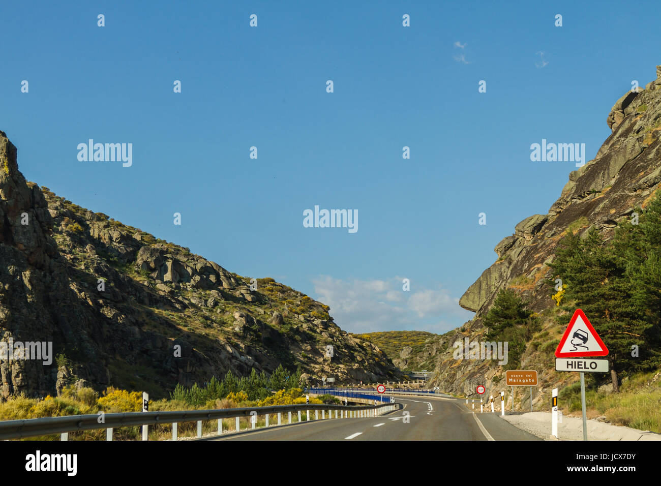 a winding road, protections and warning signs Stock Photo - Alamy