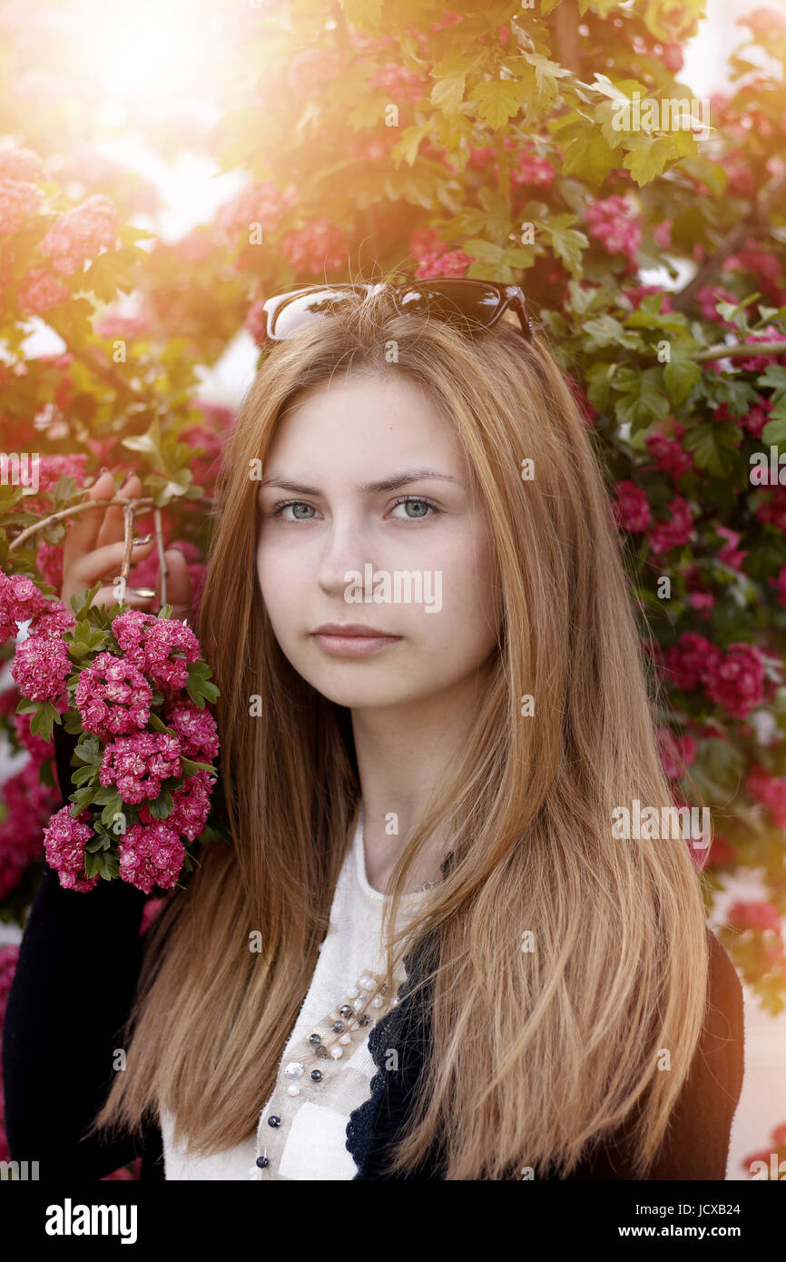 warm portrait of a young pretty girl in the park Stock Photo - Alamy