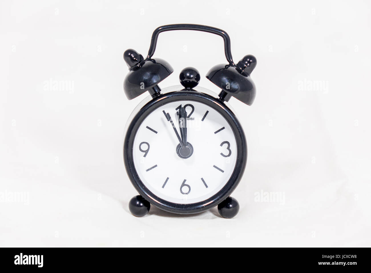 Black alarm clock on white background Stock Photo - Alamy