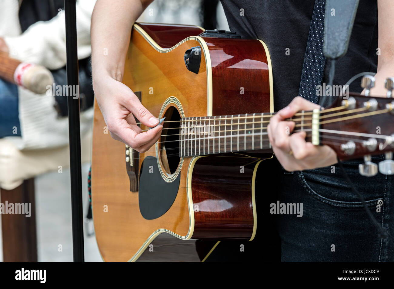 closeup of a woman's hands playing acoustic guitar outdoors concert ...