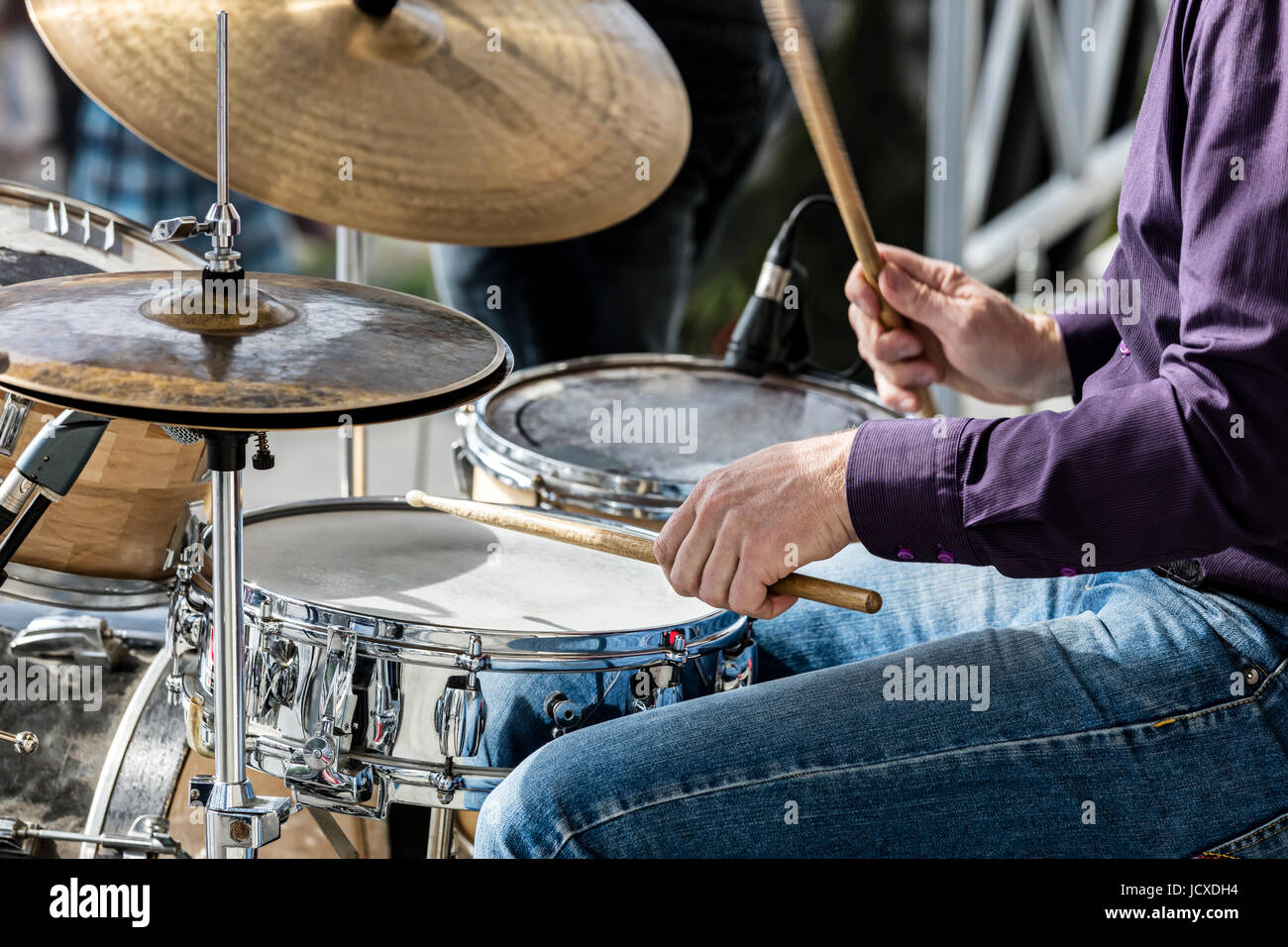 hands of musician while playing drums during street concert closeup ...