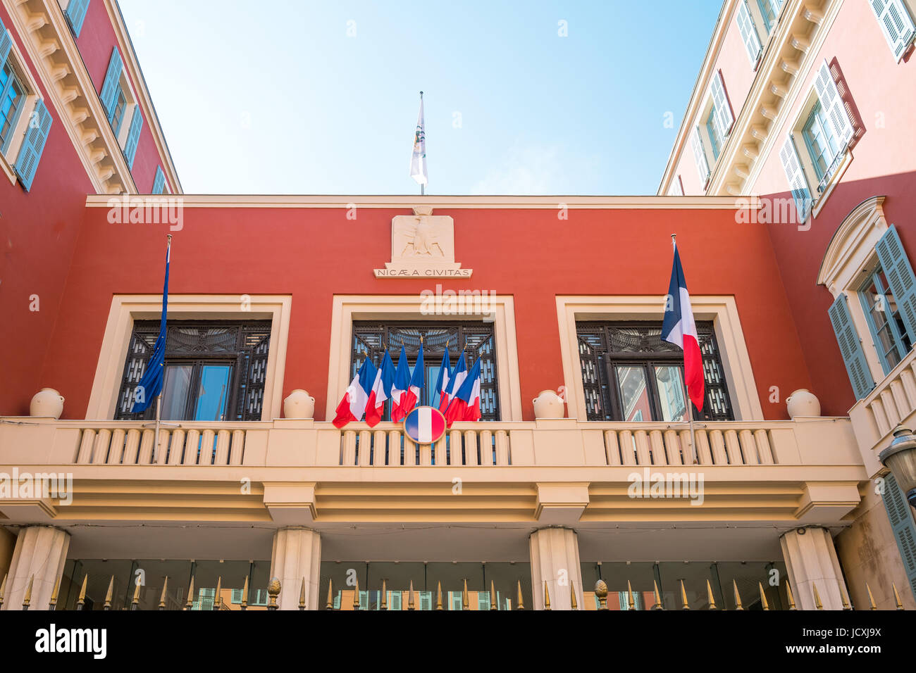 Nice, France - March 19, 2016: The facade with flags of the town hall ...