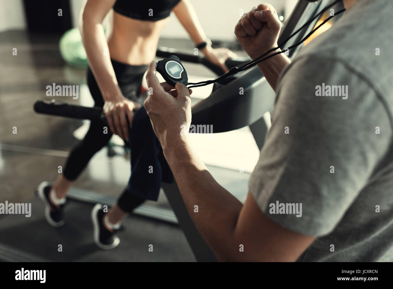 woman workout on treadmill and trainer with timer, side view Stock ...
