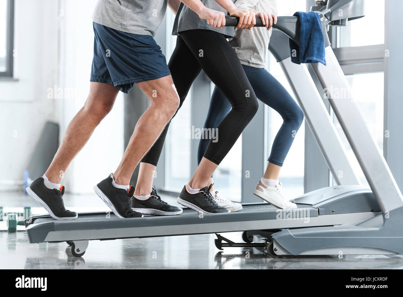 Family workout on treadmill, side view Stock Photo - Alamy