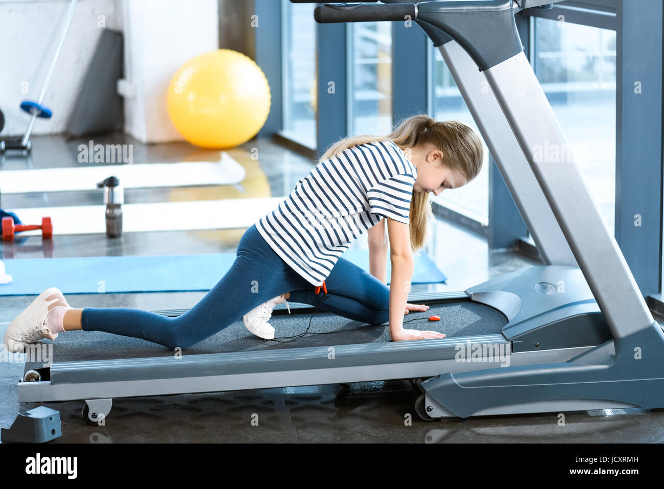 girl stretching on treadmill before training Stock Photo - Alamy