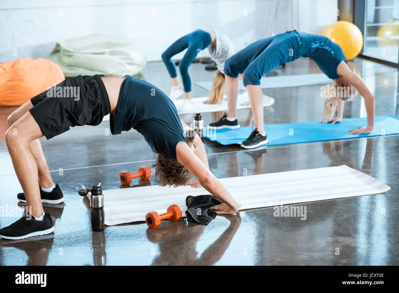People doing gymnastics, performing Bridge pose at fitness studio Stock ...