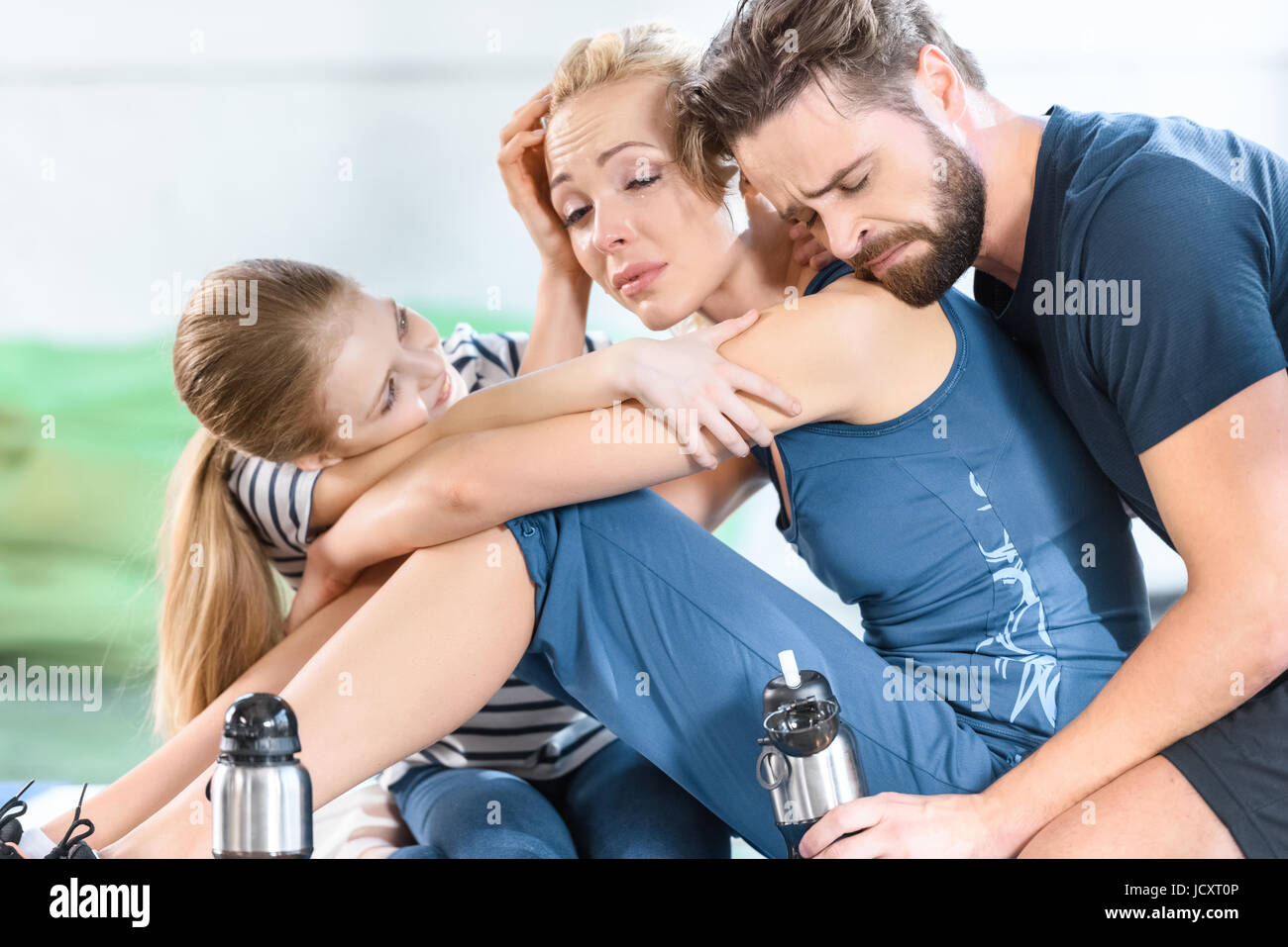 Tired family resting after workout at gym Stock Photo - Alamy