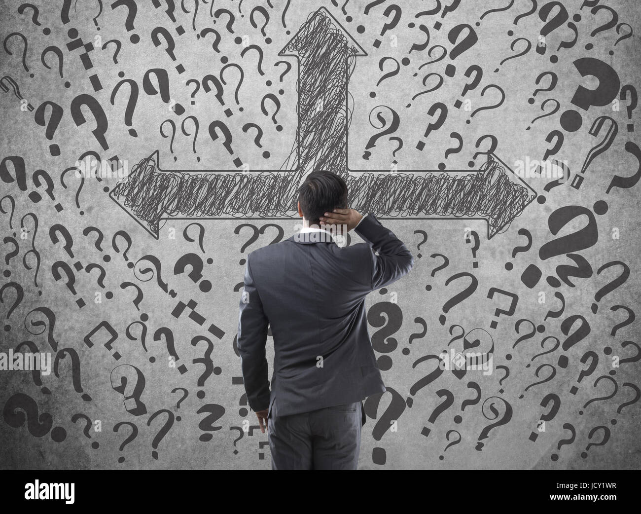 Confused businessman looking at arrow directional signs and question ...