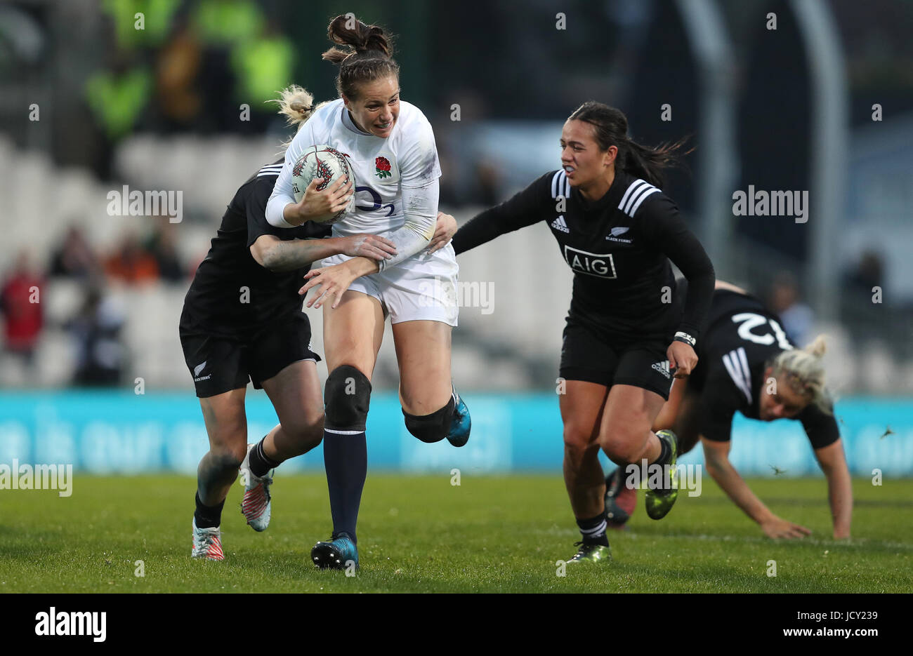 England's Emily Scarratt is tackled by New Zealand's Kelly Brazier ...