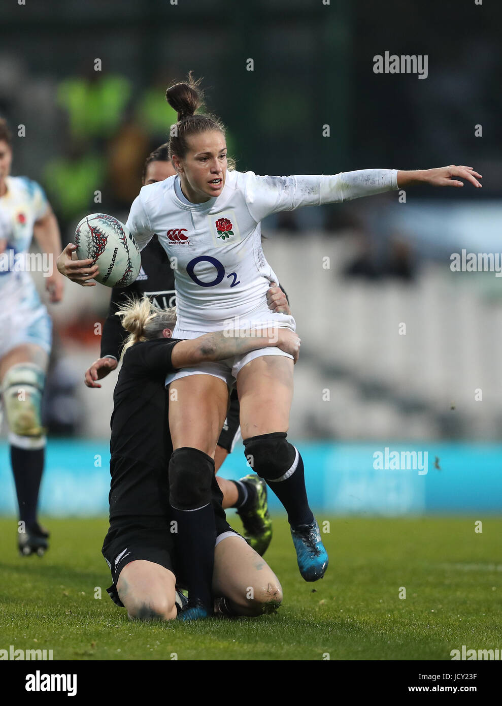 England's Emily Scarratt is tackled by New Zealand's Kelly Brazier ...