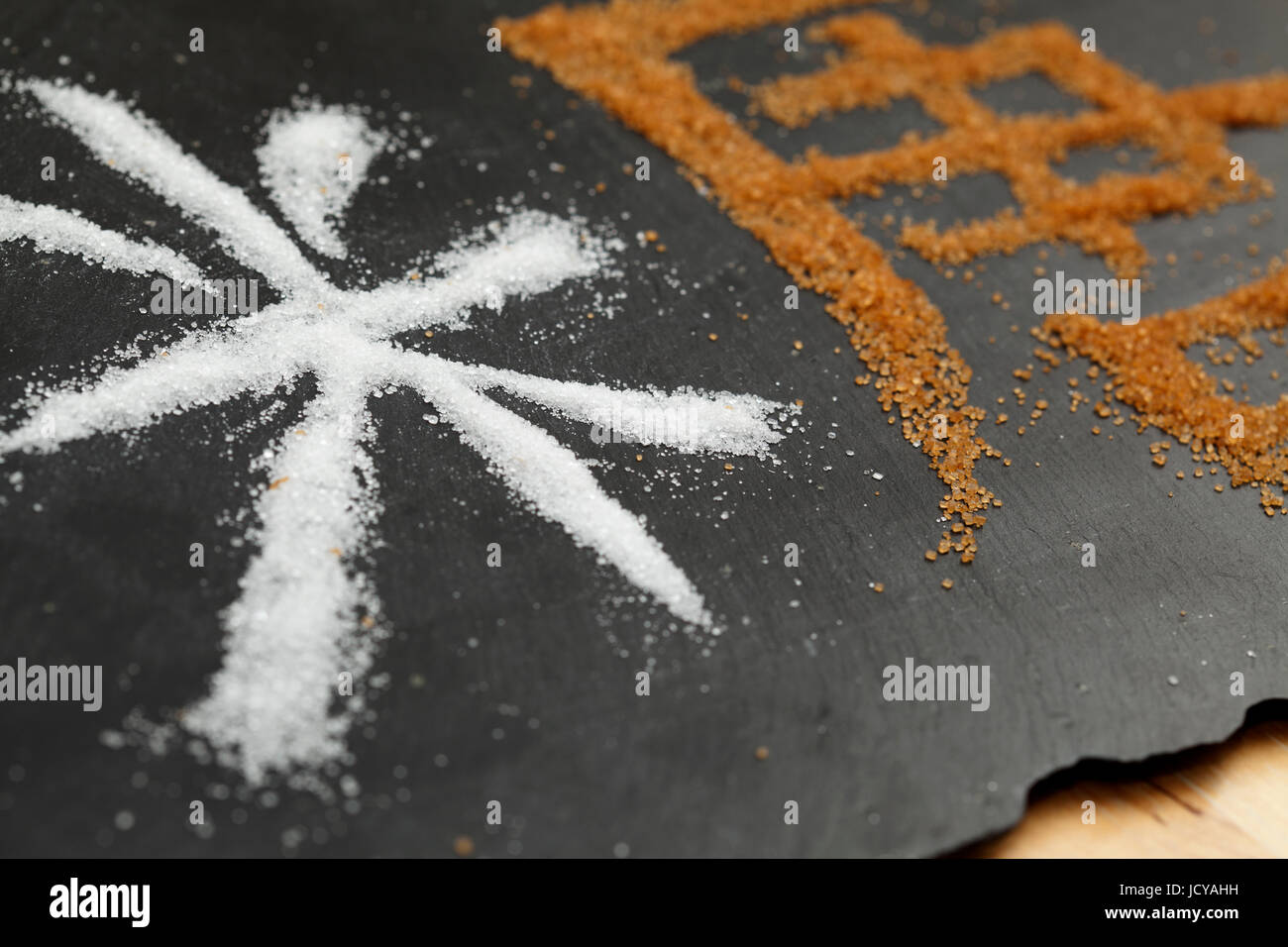 Chinese character tang - sugar, made of white and brown sugar, on black ...