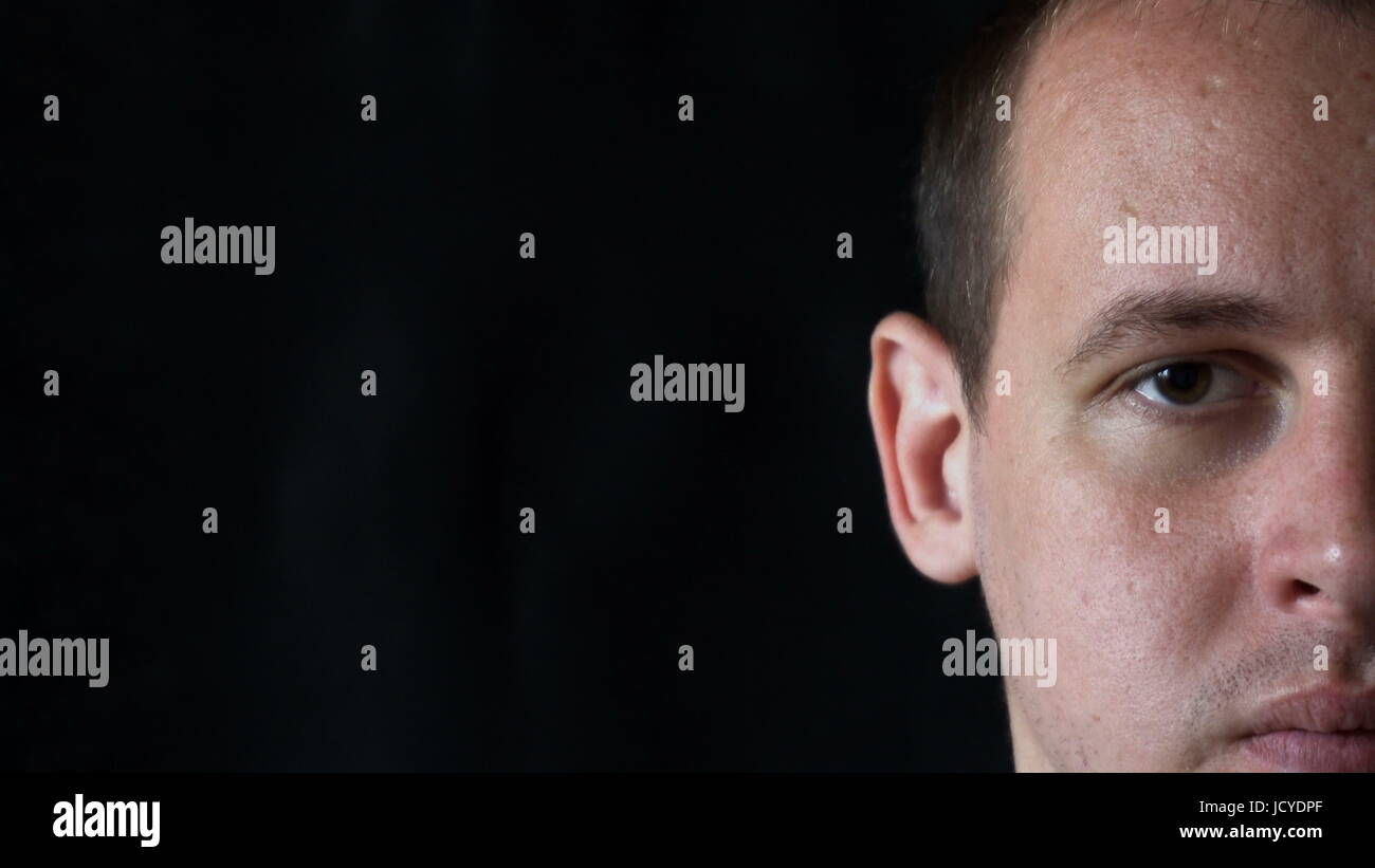 portrait of a young man staring at camera,black background Stock Photo ...
