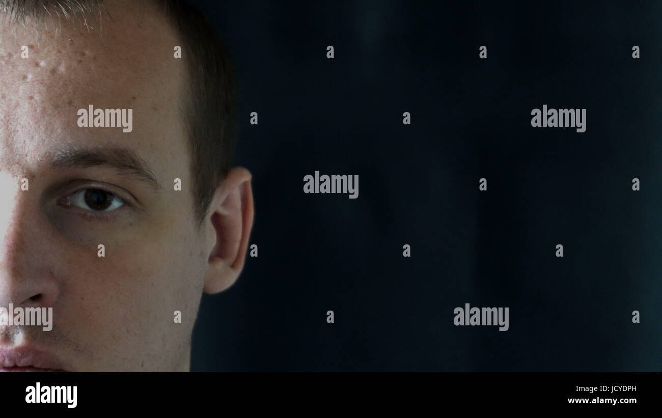 portrait of a young man staring at camera,black background Stock Photo ...