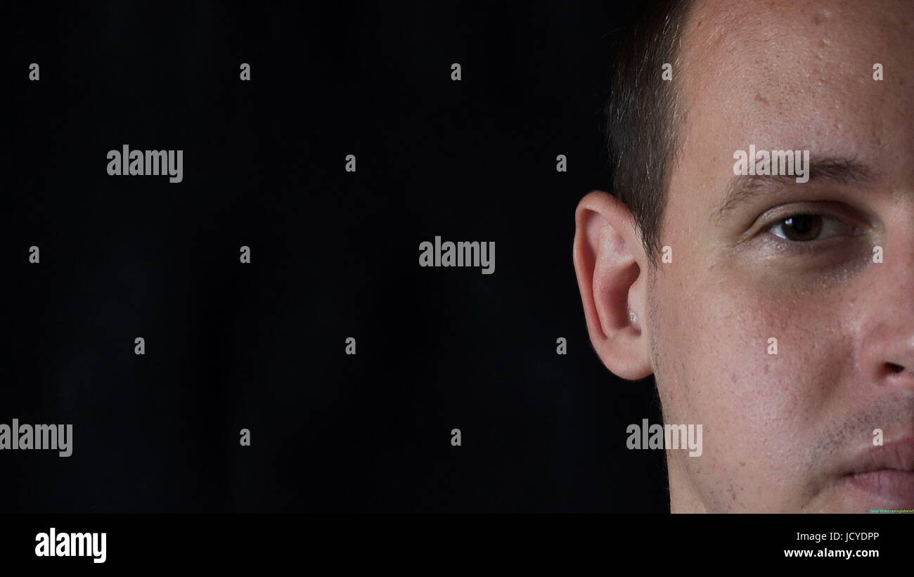 portrait of a young man staring at camera,black background Stock Photo ...