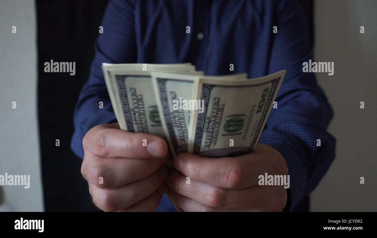 American dollar counts man holding hi-res stock photography and images - Alamy