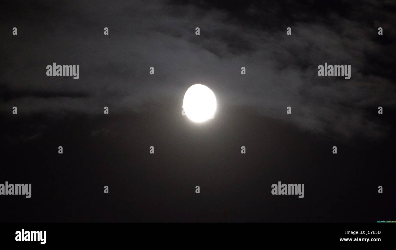 timelapse with moon moving between clouds best for web use Stock Photo ...