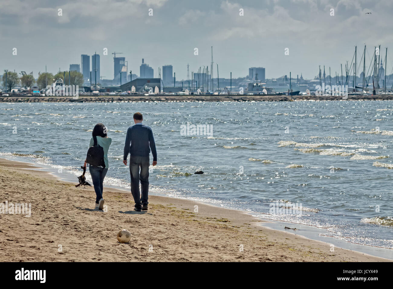 A man and a women having a quiet walk on the Pirita beach in Tallinn ...