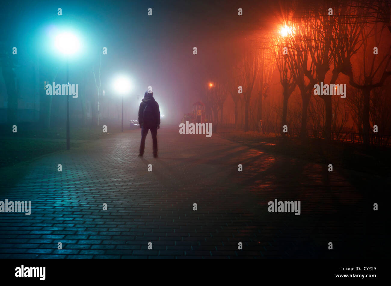 man stand alone at the foggy street Stock Photo - Alamy