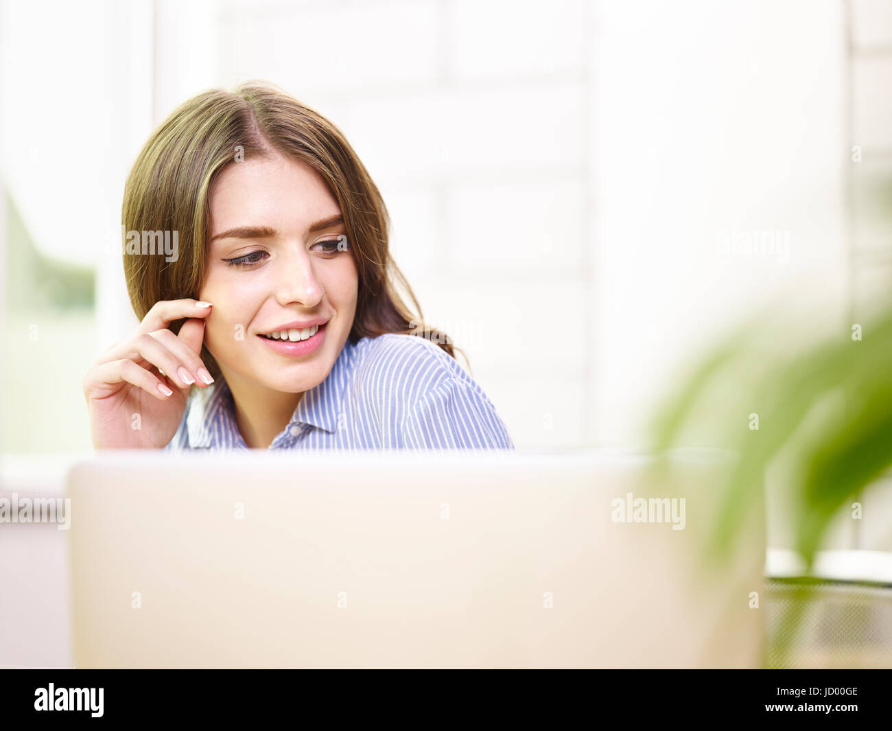 young caucasian businesswoman working in office using laptop computer ...