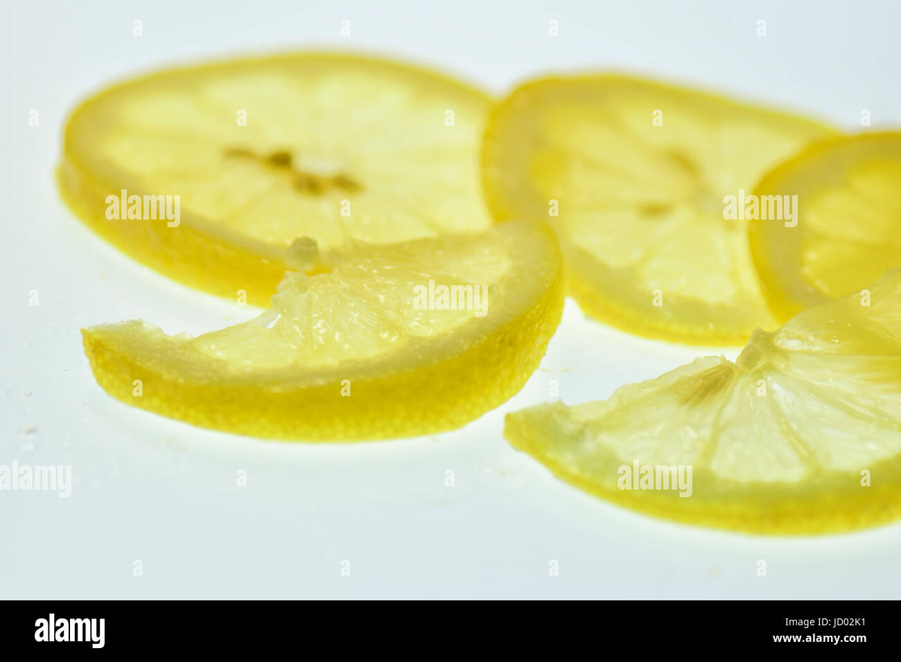 Freshly sliced lemons on white background Stock Photo - Alamy