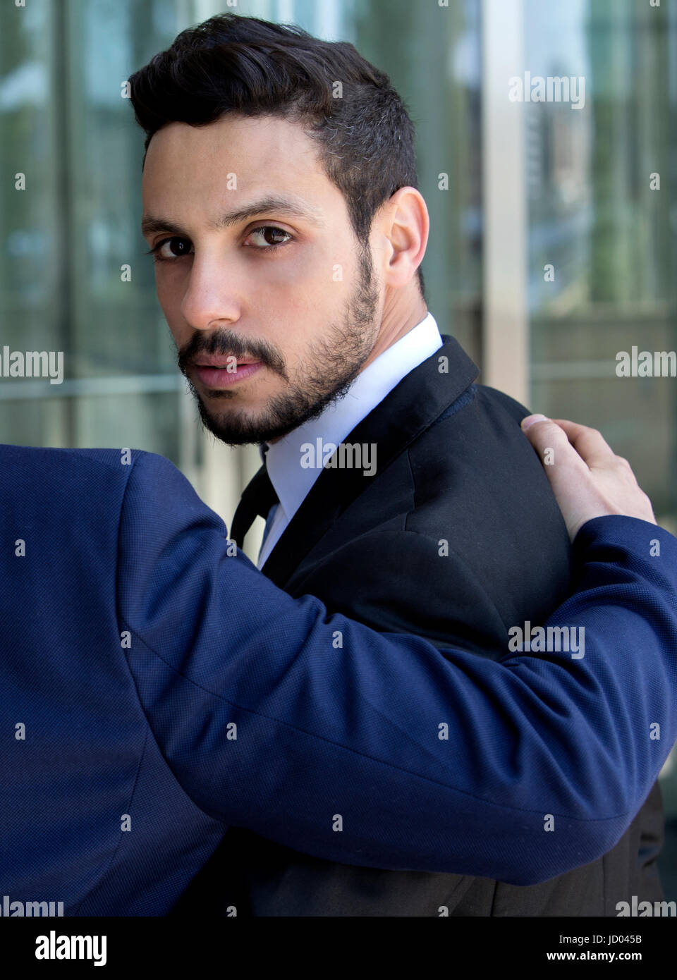 handsome businessman looking over his shoulder at camera Stock Photo ...