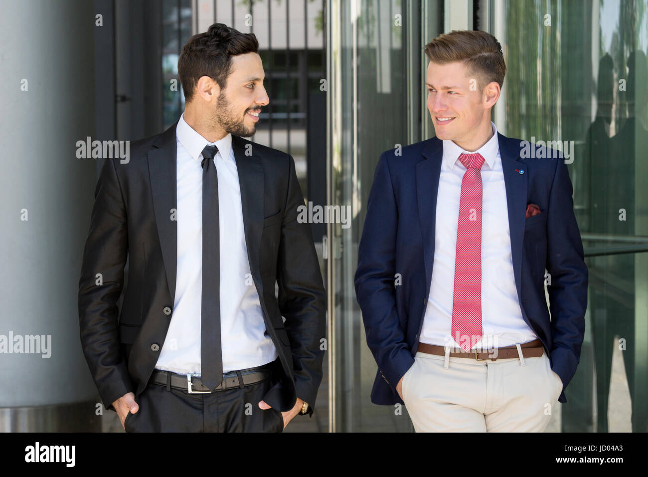 two handsome businessmen greeting each other outside Stock Photo - Alamy