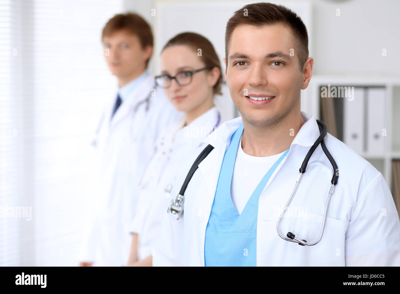 Cheerful smiling male doctor with medical staff at the hospital Stock ...