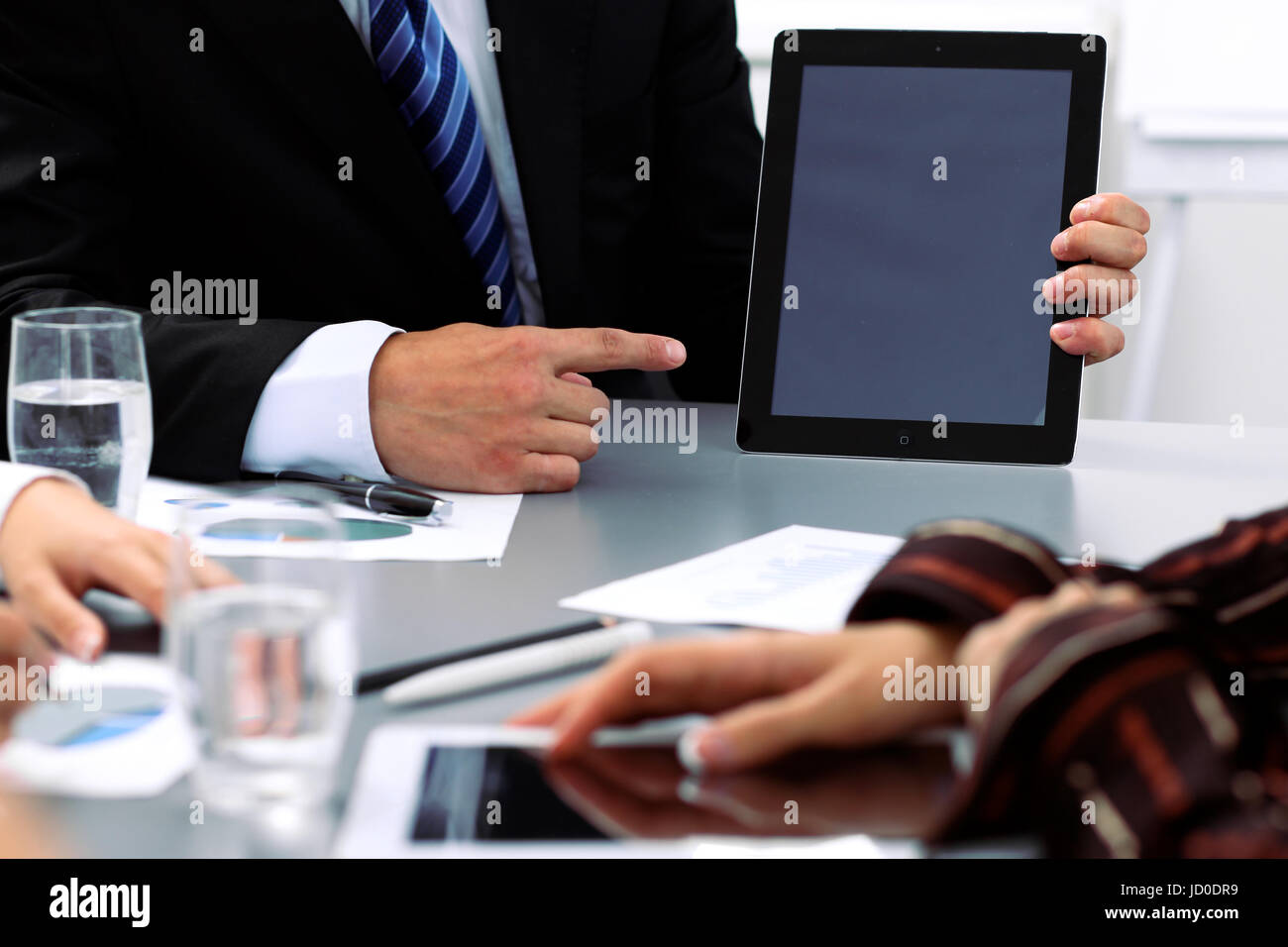 Group of business people at meeting, close up. Boss pointing into ...