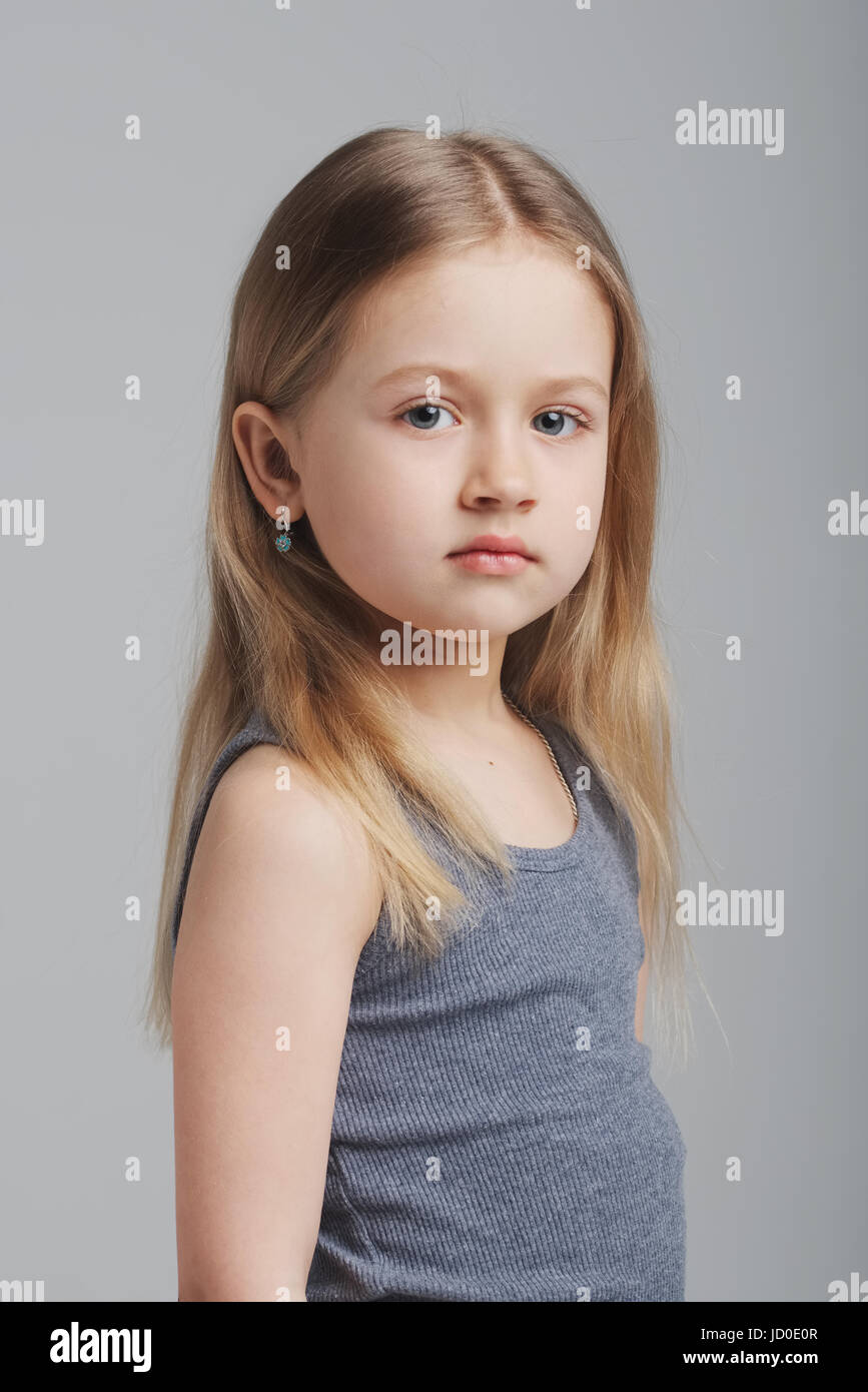 little girl studio portrait on grey background Stock Photo - Alamy