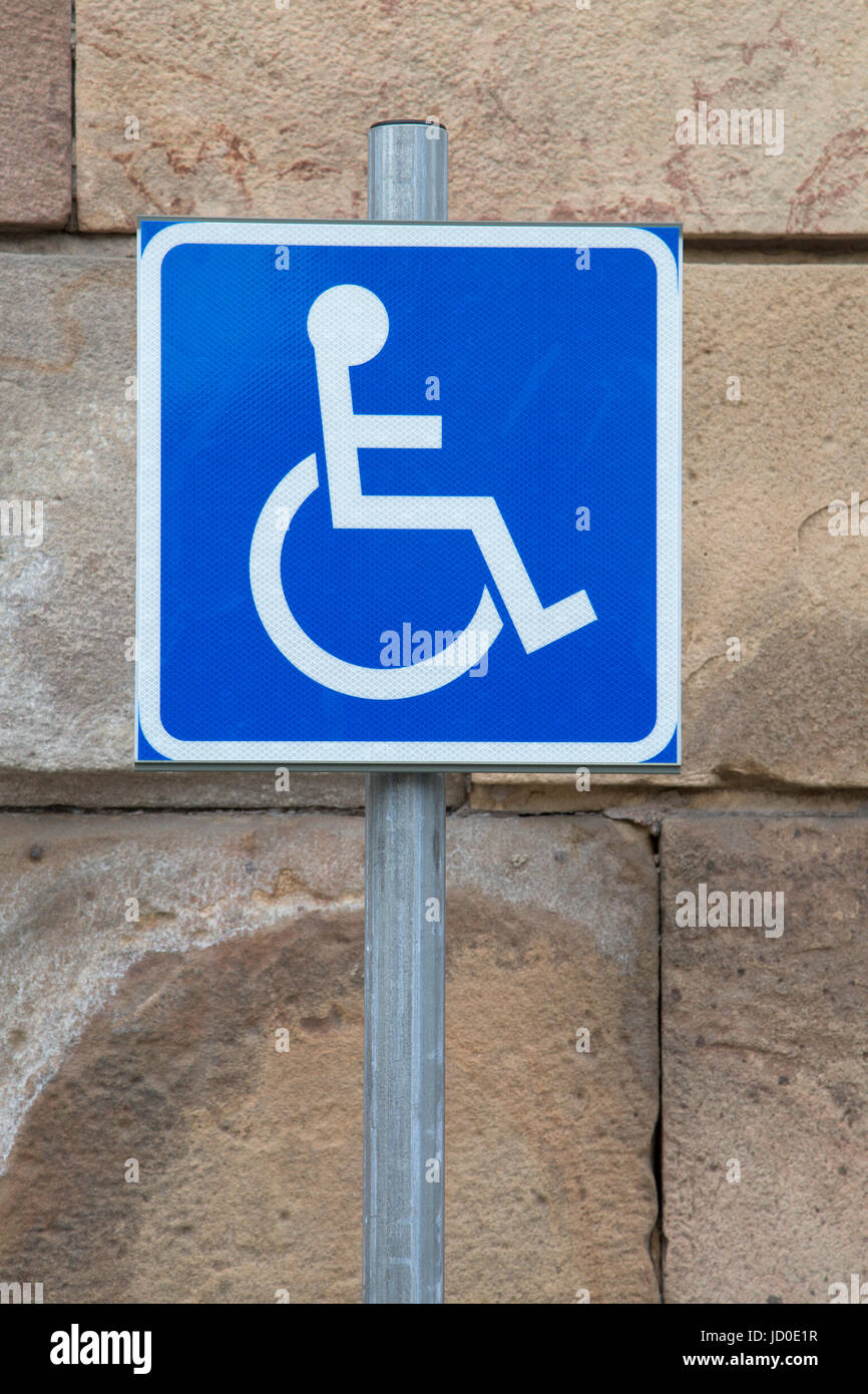 Disabled Parking Sign against Stone Wall Stock Photo - Alamy