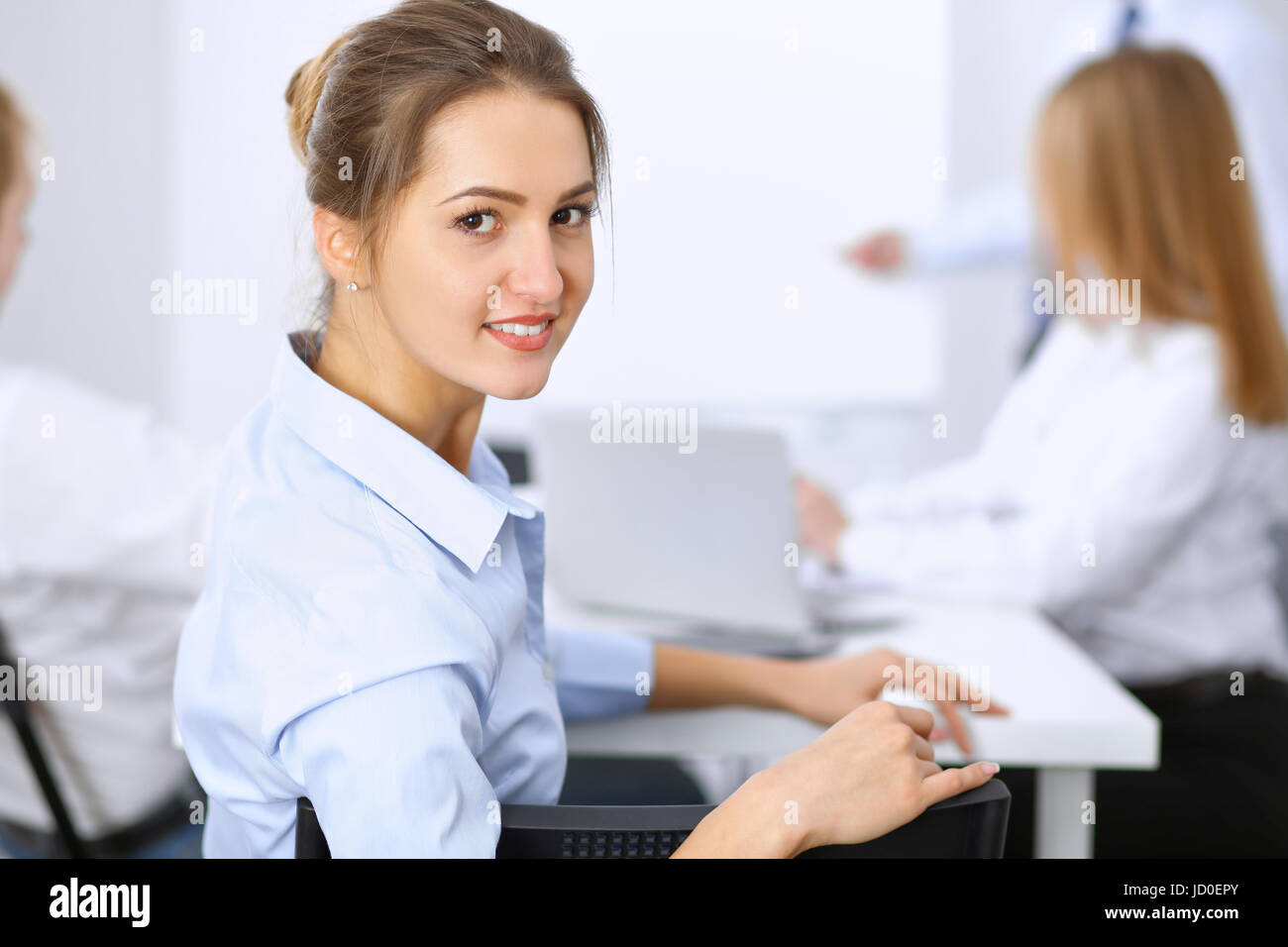 Beautiful business woman on the background of business people during ...