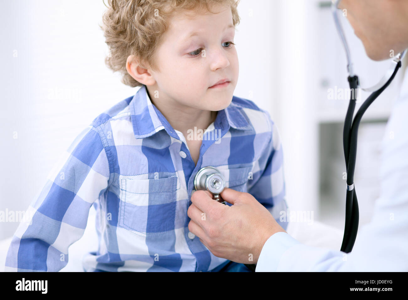 Doctor examining a child patient by stethoscope Stock Photo - Alamy