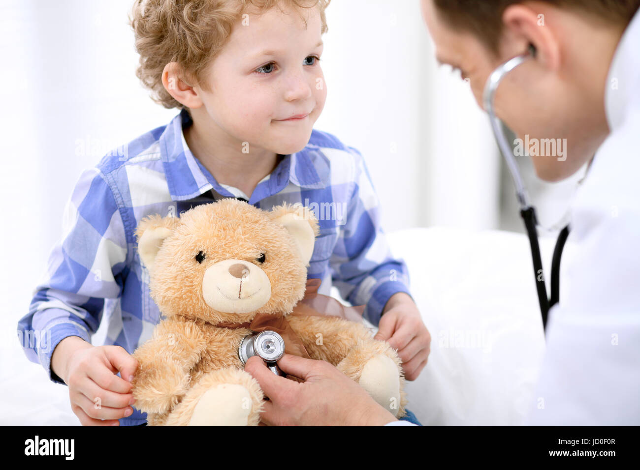 Doctor examining a child patient by stethoscope Stock Photo - Alamy