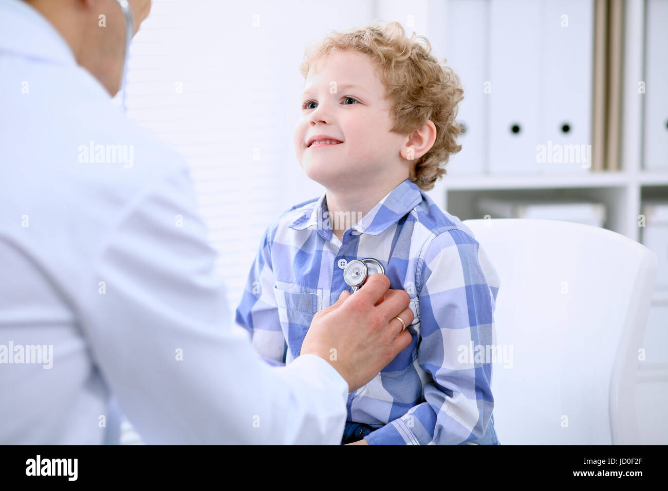 Doctor examining a child patient by stethoscope Stock Photo - Alamy