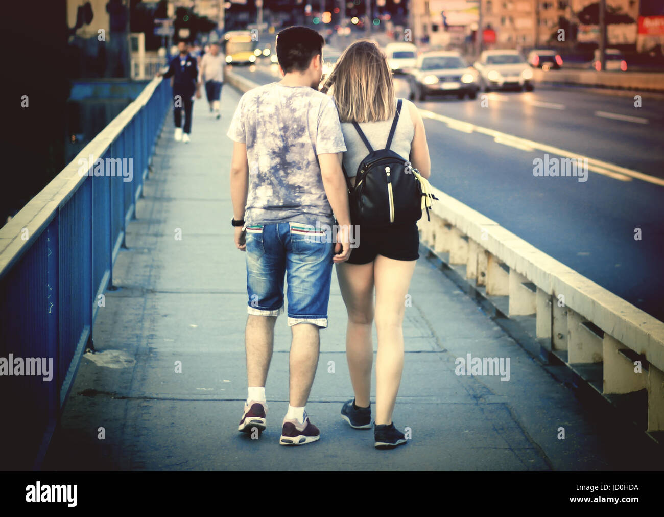Pair walking over the bridge Stock Photo - Alamy