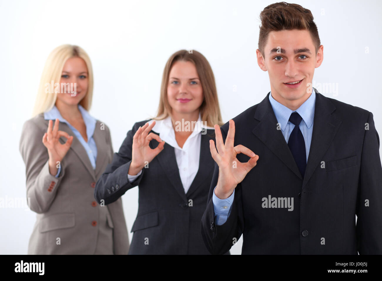 Group of business people, start-up team, ok hand sign Stock Photo - Alamy