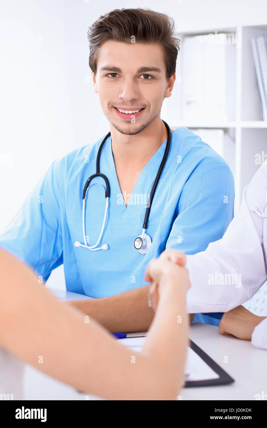 Attractive male surgeon doctor at medical meeting or patient ...