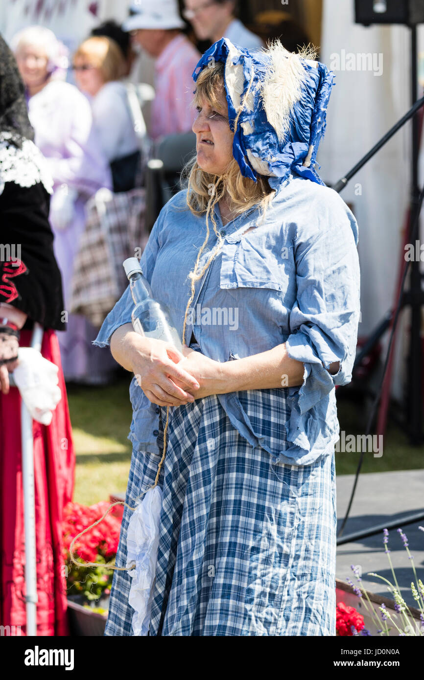 Senior woman dressed up in Victorian costume, as Sarah Gamp, drunken ...