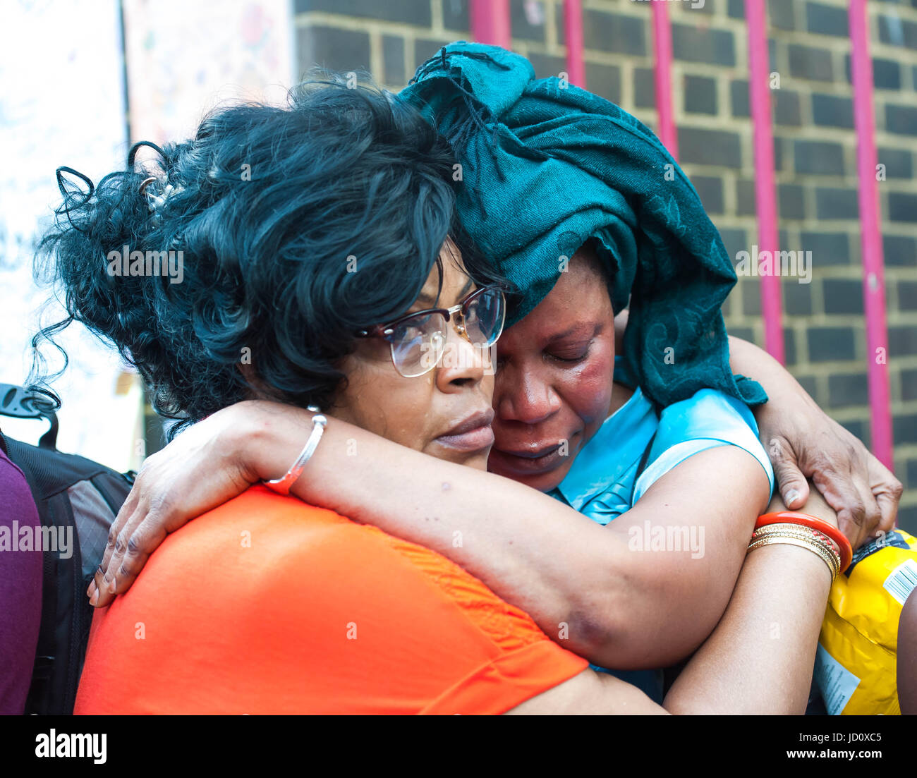 London, United Kingdom. 17th June 2017. Two women crying as they bring ...