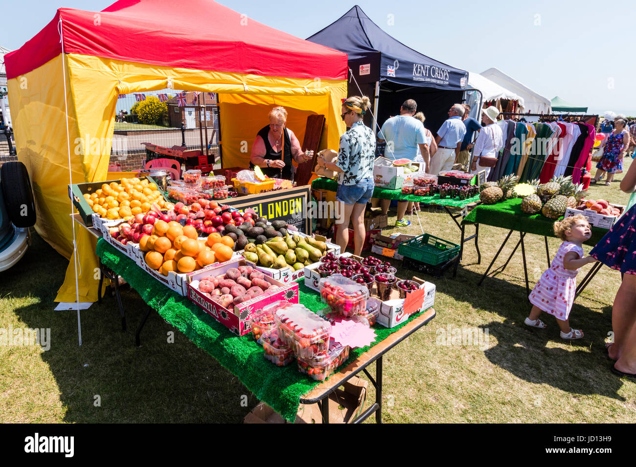 Fresh fruit tented market stall at event. Various fruits in boxes on ...