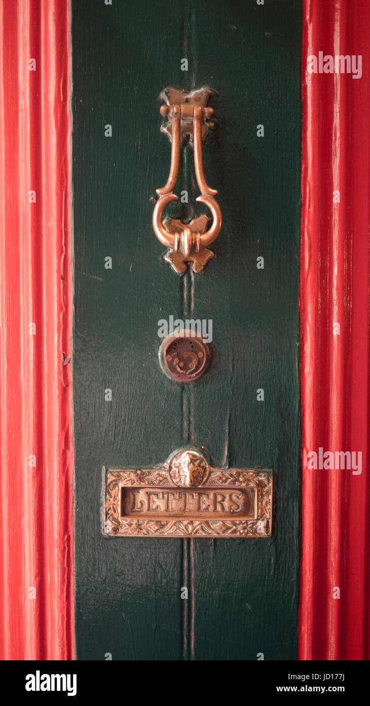 Door knocker. An old front door with a fancy knocker and letter box ...