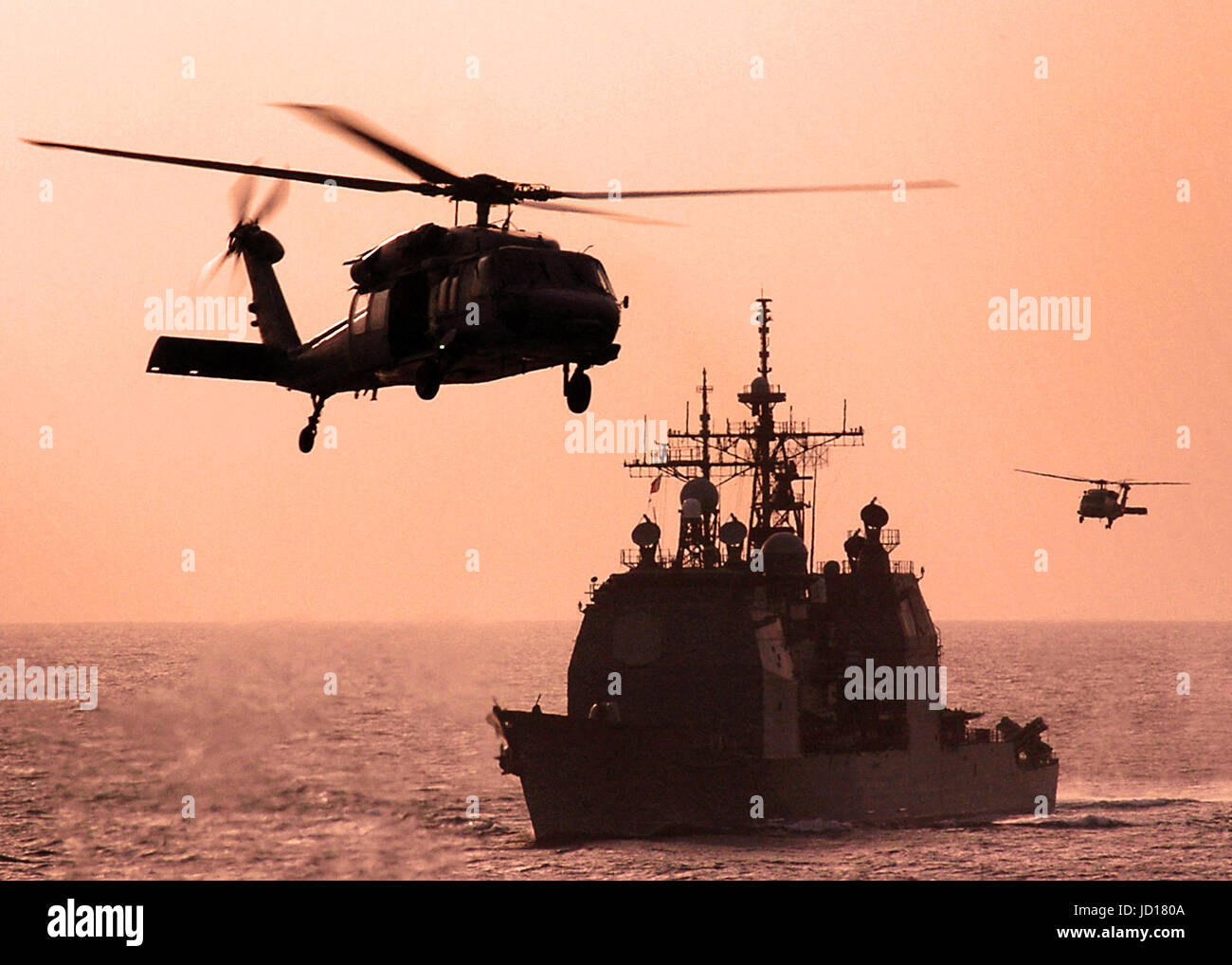 Two MH-60S Knighthawk helicopters above the USS Monterey (CG 61) as ...