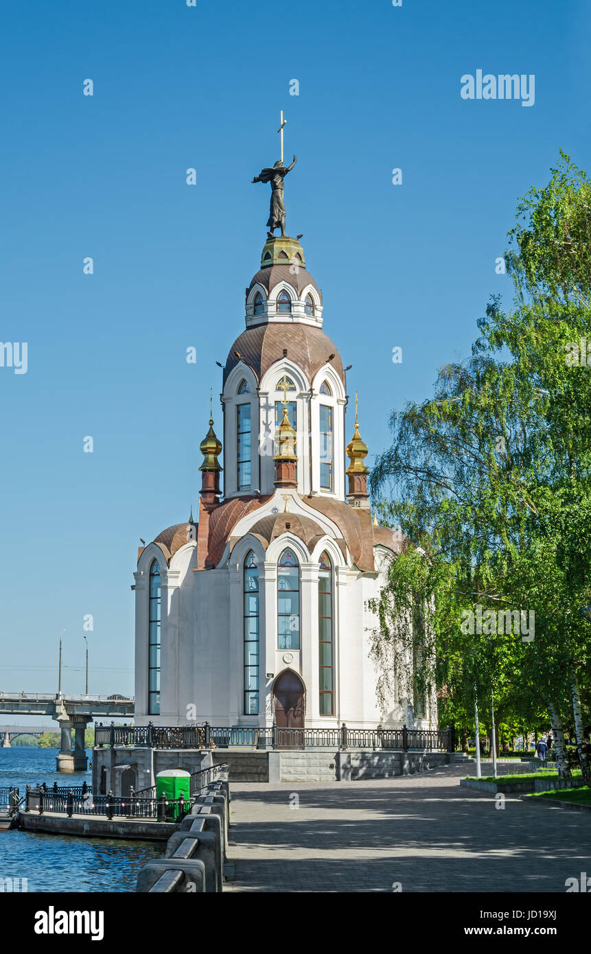 Orthodox temple on the waterfront against the blue sky in early spring ...