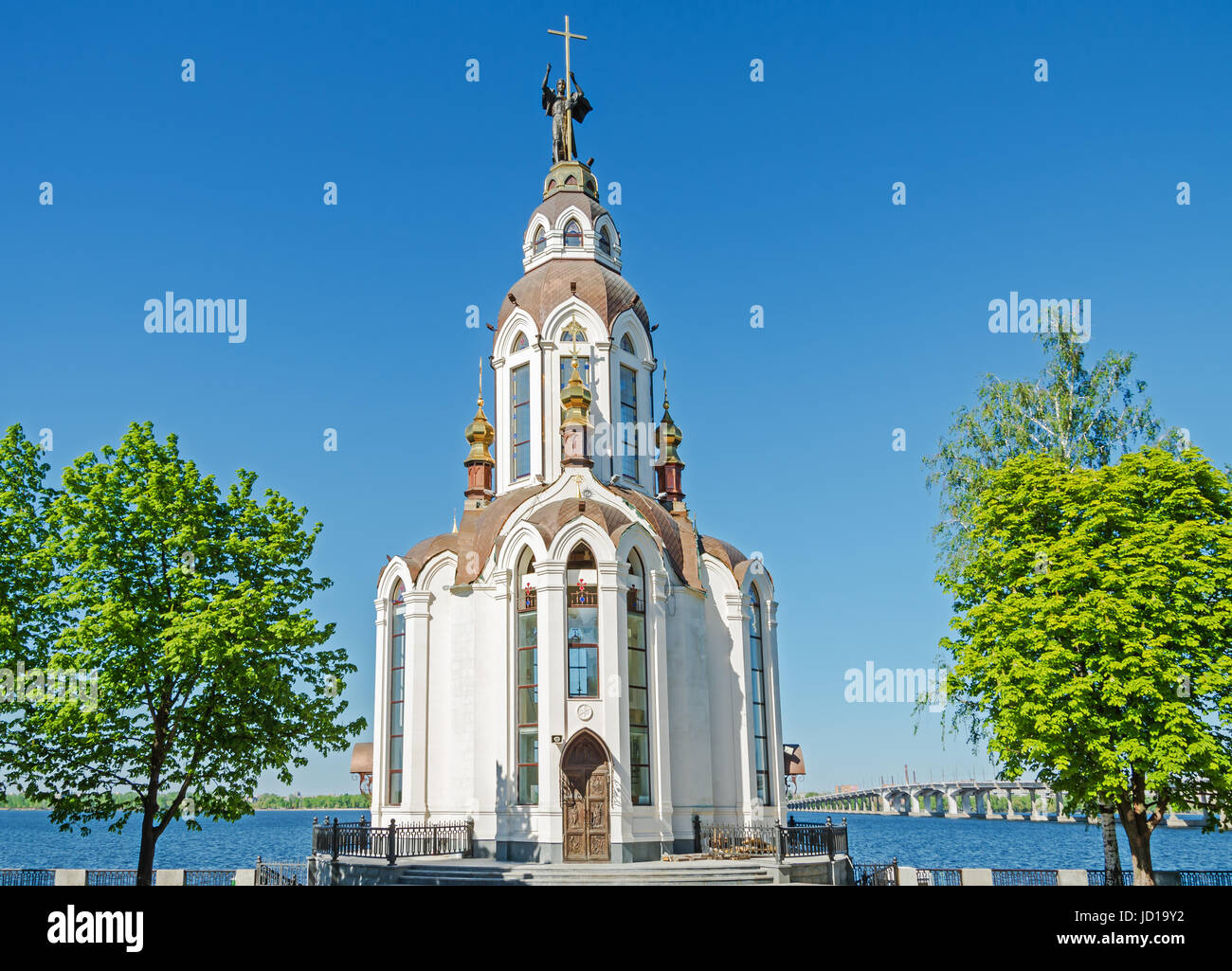 Orthodox temple on the waterfront against the blue sky in the middle ...