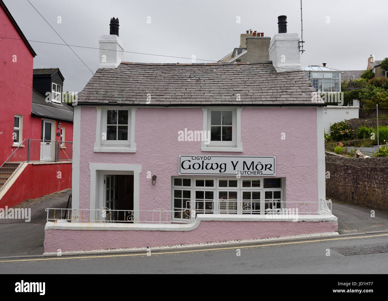 Pink painted butcher shop with slate roof, built on slope in west wales ...