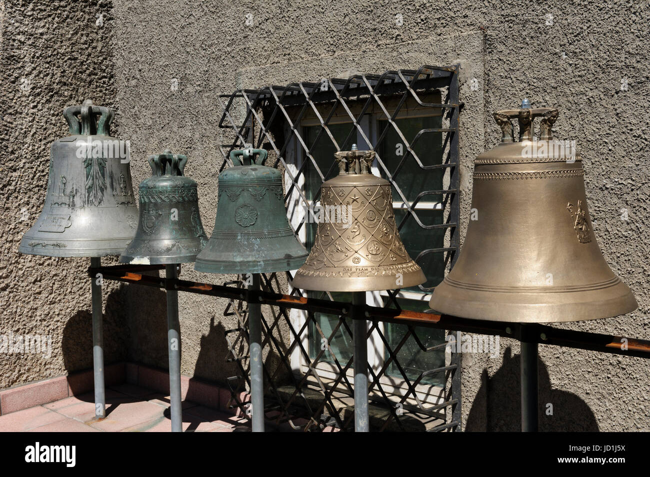 Bells of different sizes on display in the courtyard of the Grassmayr ...