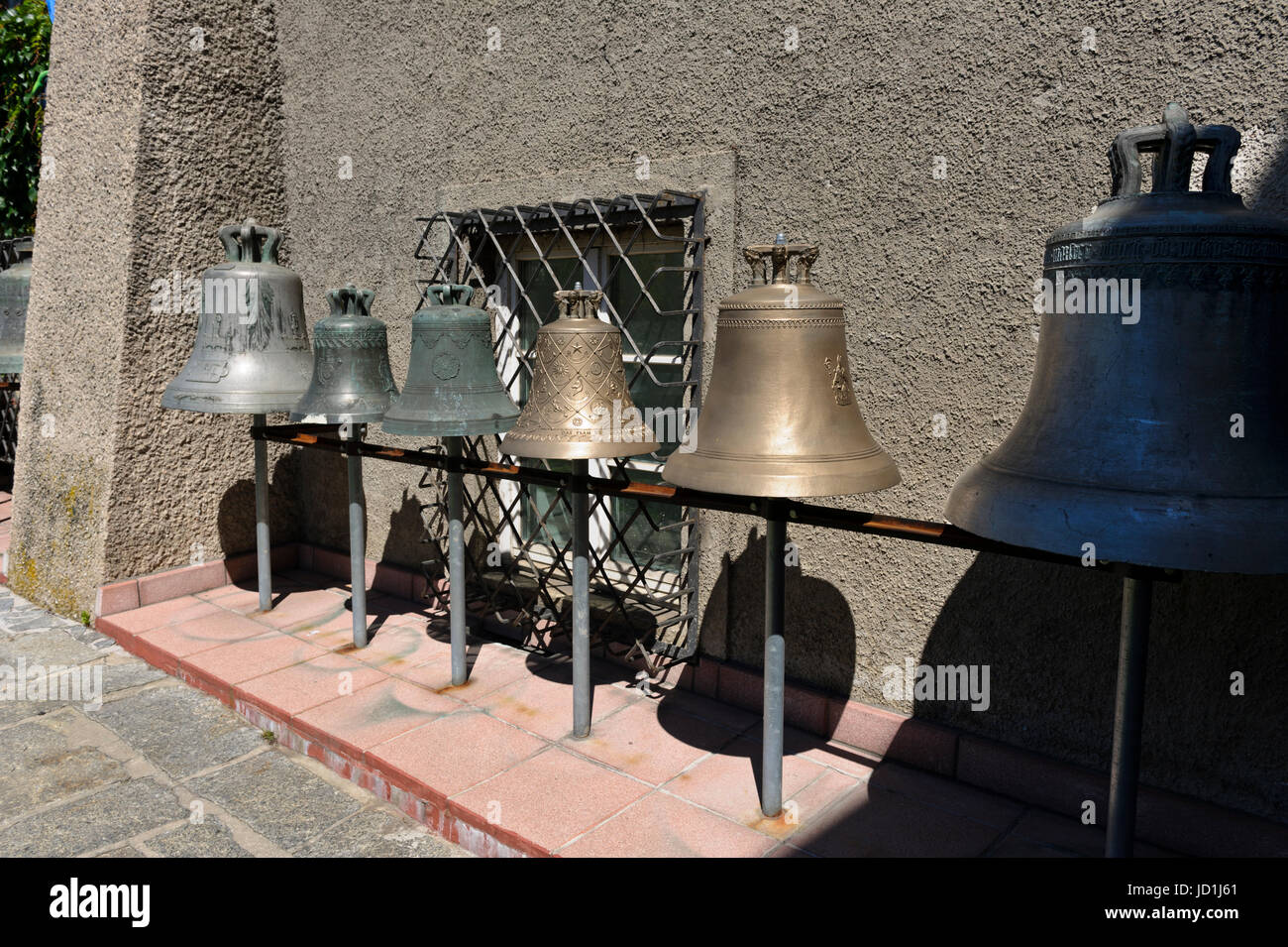 Bells of different sizes on display in the courtyard of the Grassmayr ...